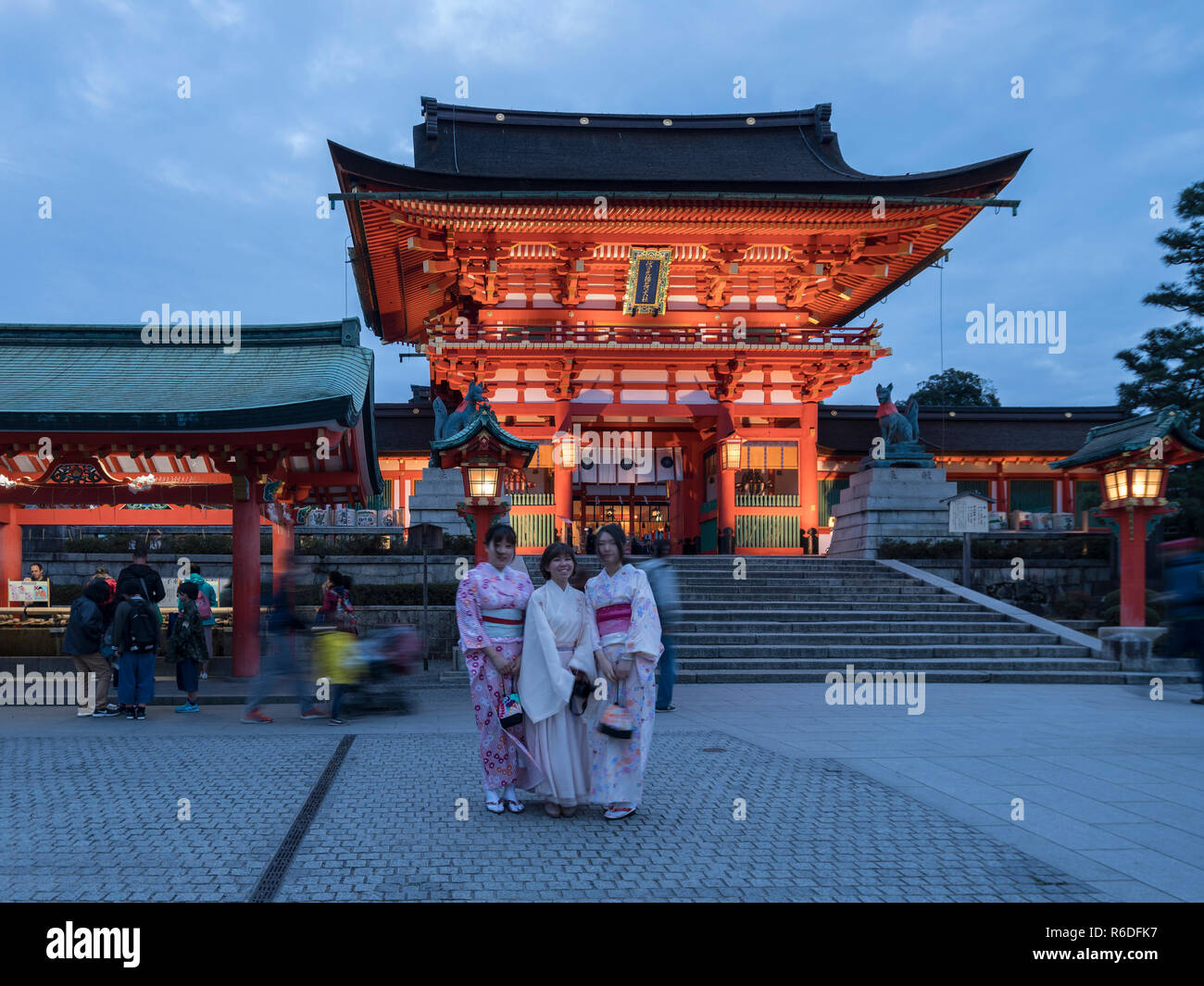 Women wearing Kimono posing for photo in front of Fushimi Inari-taisha ...
