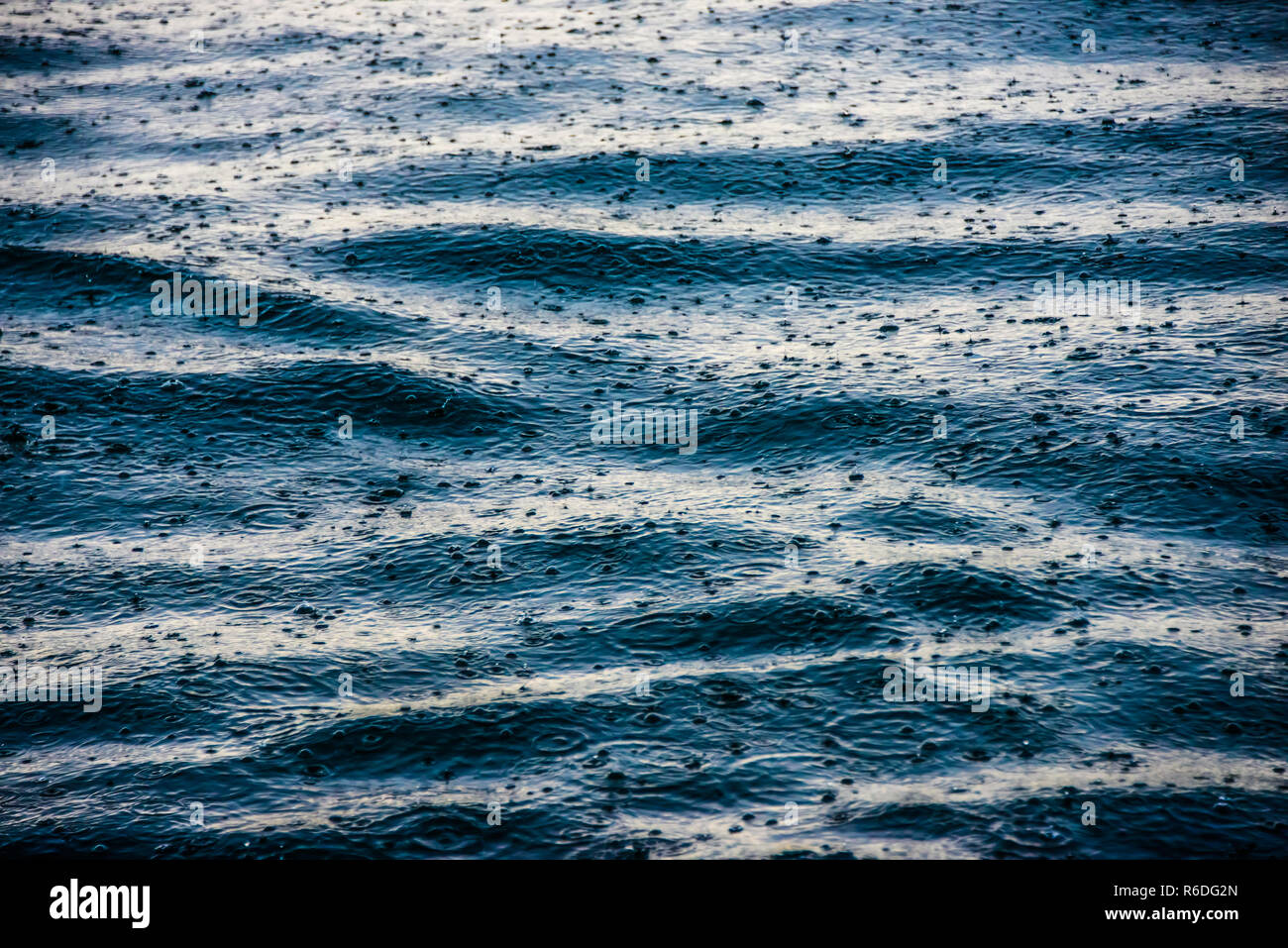 Rain drops on water wave rippels Stock Photo - Alamy
