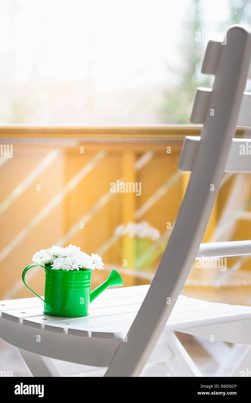 Flowers bouquet on a chair in front of windows Stock Photo - Alamy