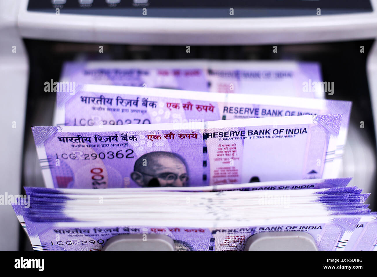 100 rupees notes in the money counting machine. Isolated on the white ...