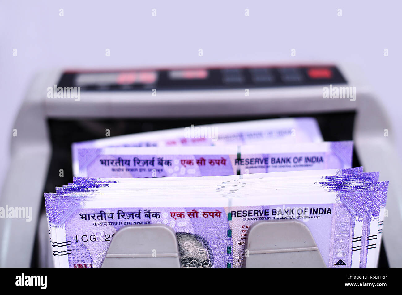 Counting of new Indian currency on automatic machine. Isolated on the ...