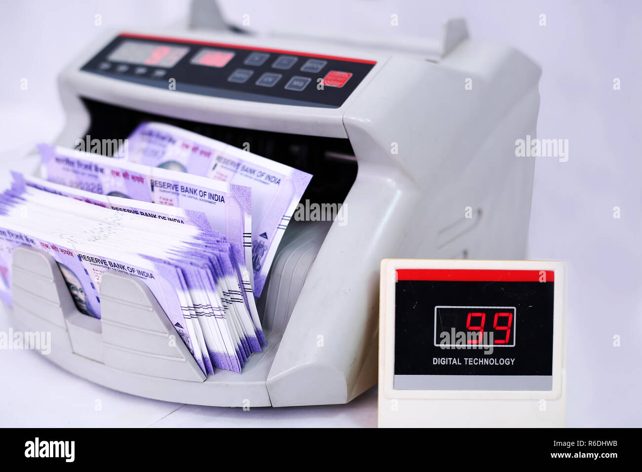 Electronic currency counter machine with new Indian currency. Isolated ...