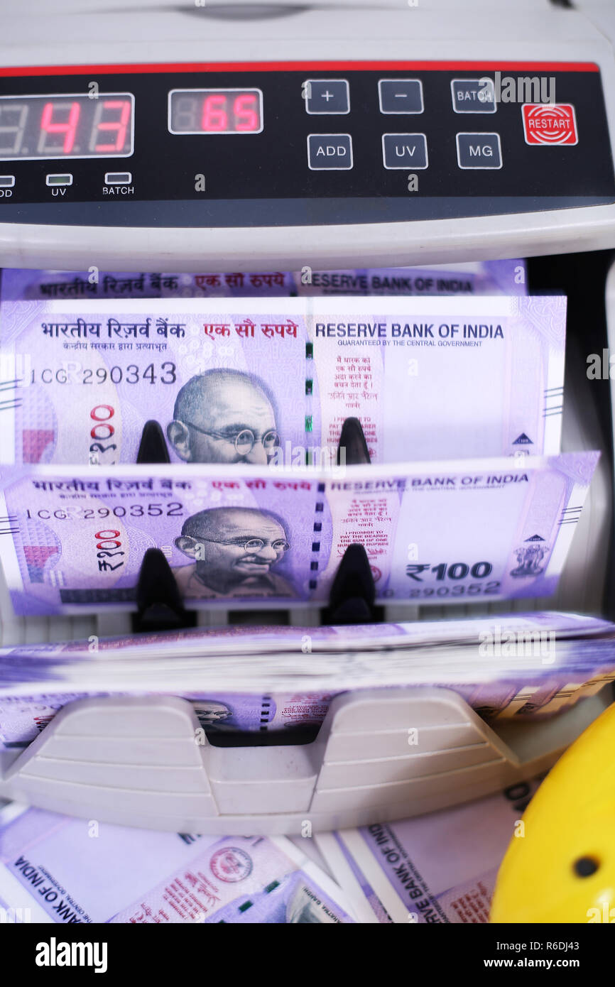 Picture of new Indian currency, cash counting machine and yellow piggy ...