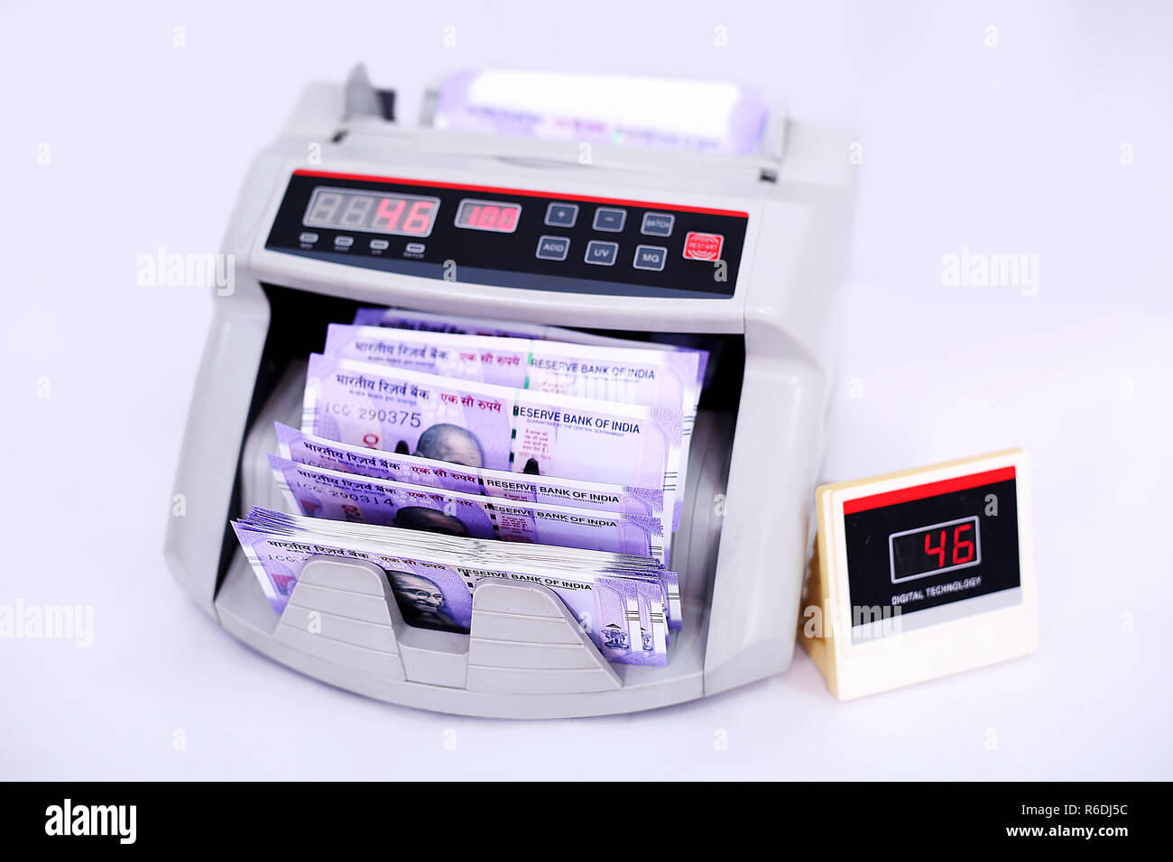 Electronic money counter with new Indian 100 rupees notes. Isolated on ...