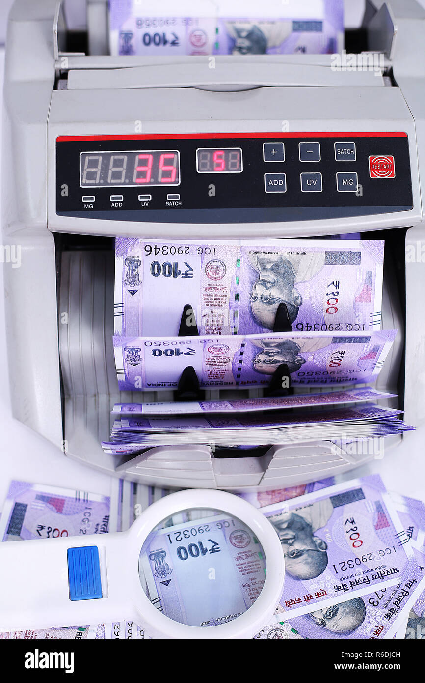 Picture of new Indian currency, cash counting machine and magnifying ...