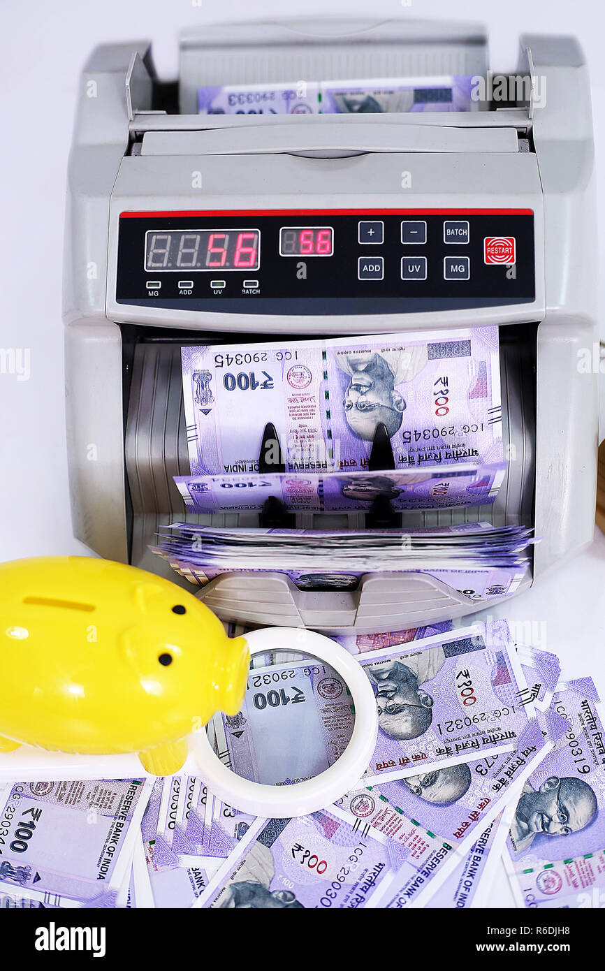 Portrait of new Indian currency, cash counting machine, magnifying ...
