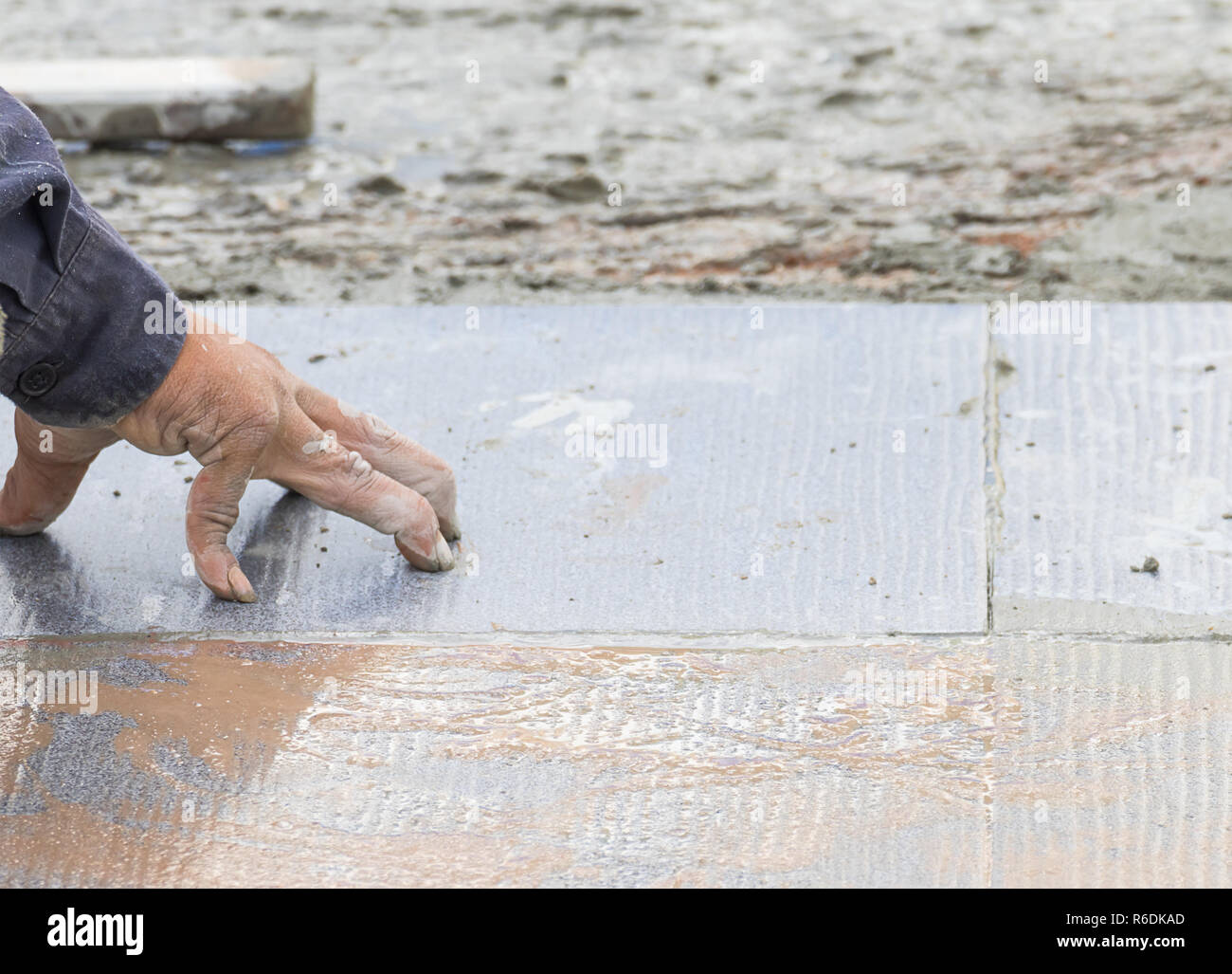 Mason repairing the tiles Stock Photo - Alamy