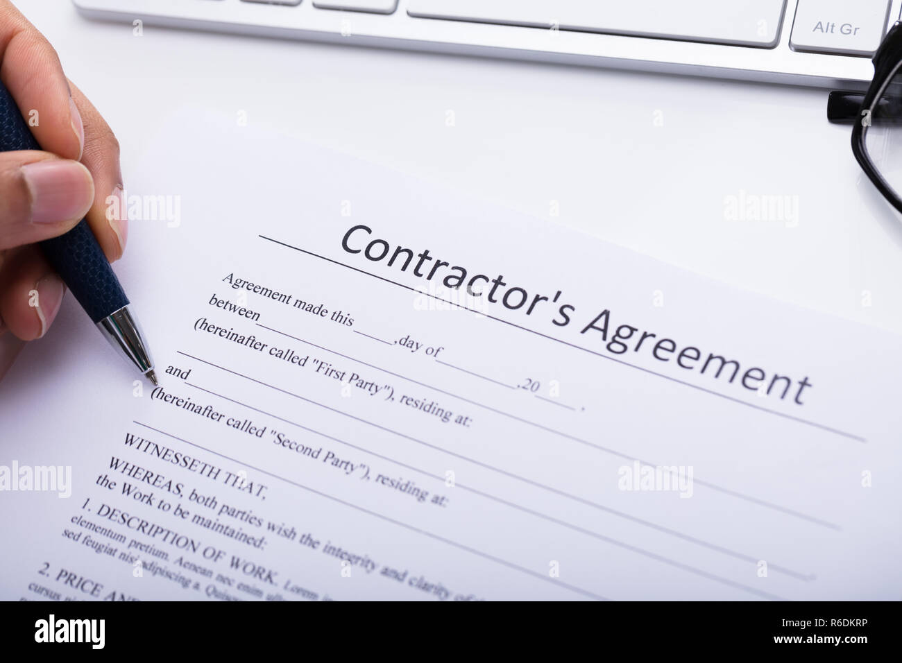 Businessperson Filling Contractor's Agreement Form Stock Photo - Alamy