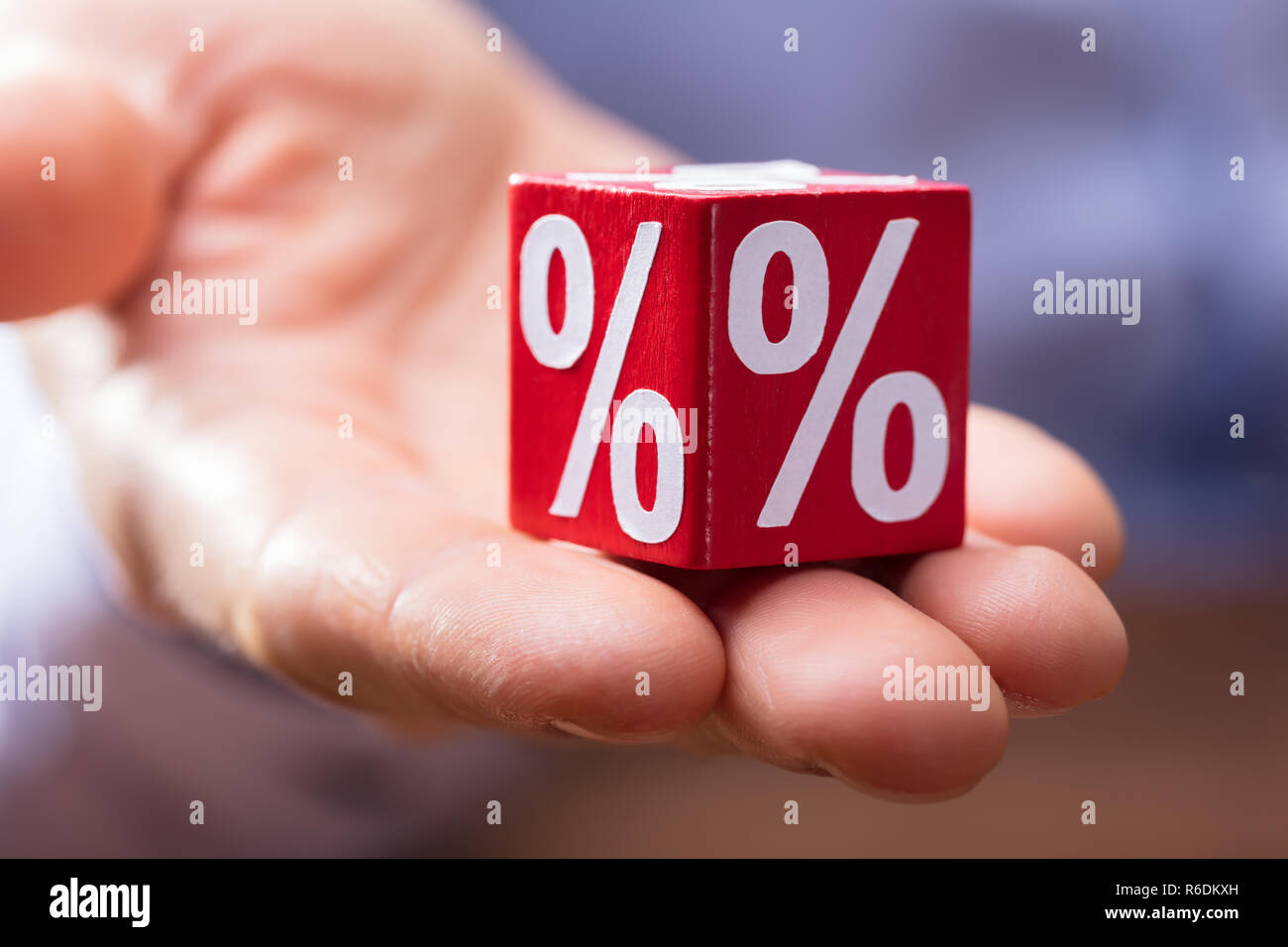 Hand Holding Red Block With Percentage Symbol Stock Photo - Alamy