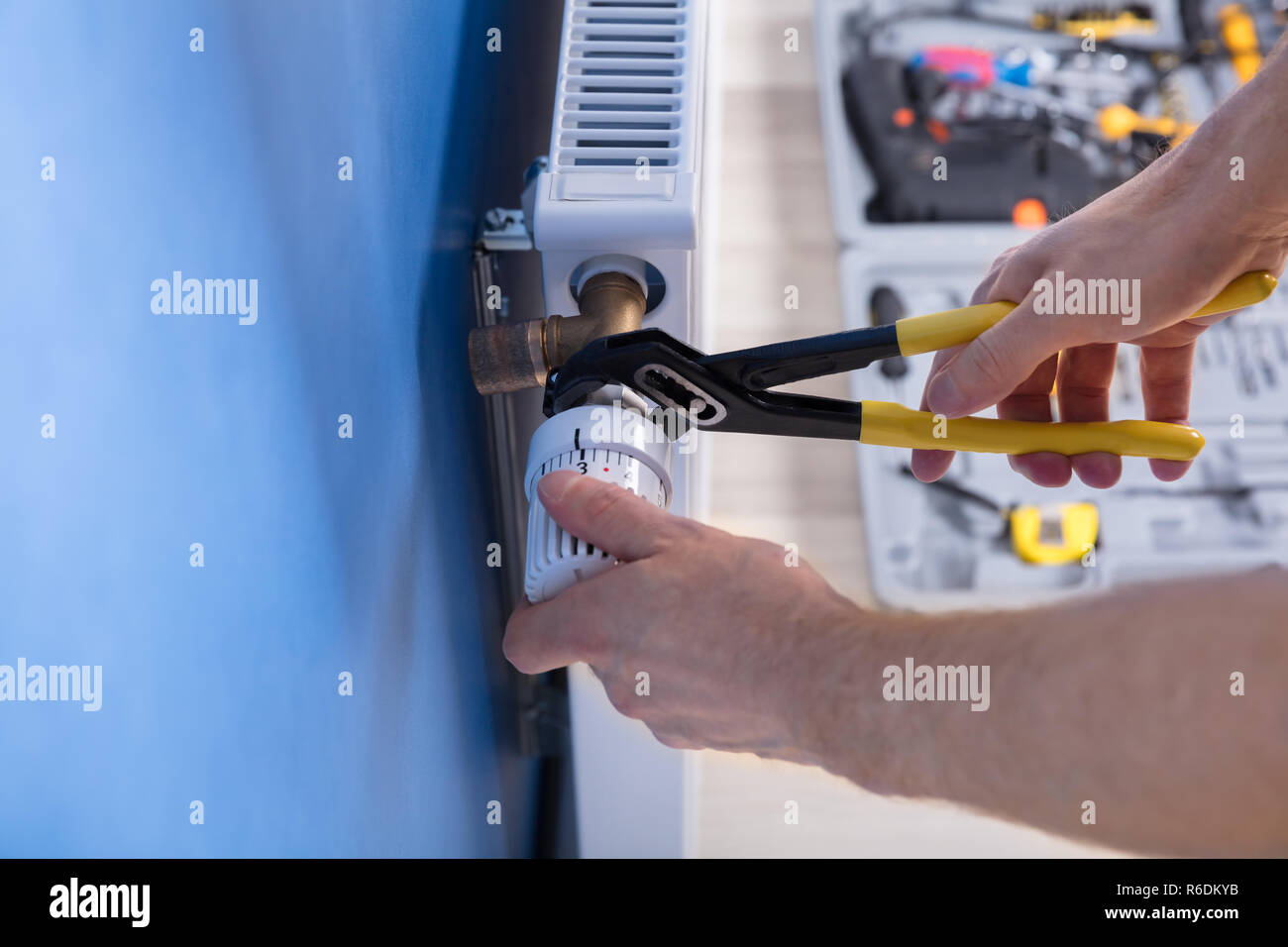 Repairman Fixing Radiator With Wrench Stock Photo - Alamy