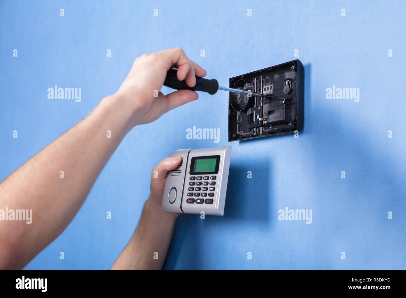 Human Hand Installing Security System Stock Photo - Alamy