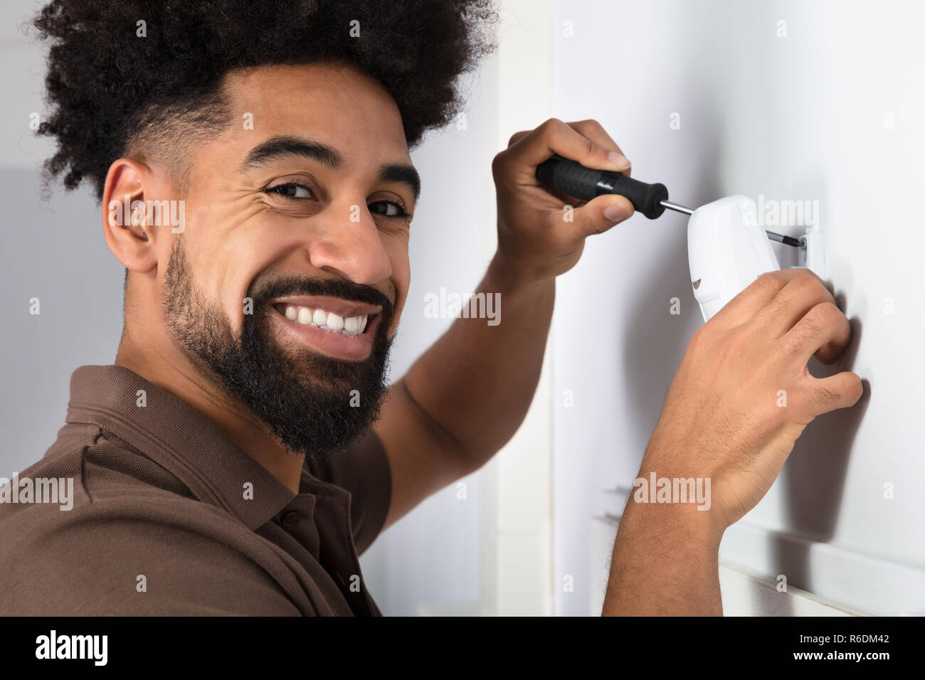 Technician Installing Security System Motion Sensor Stock Photo - Alamy