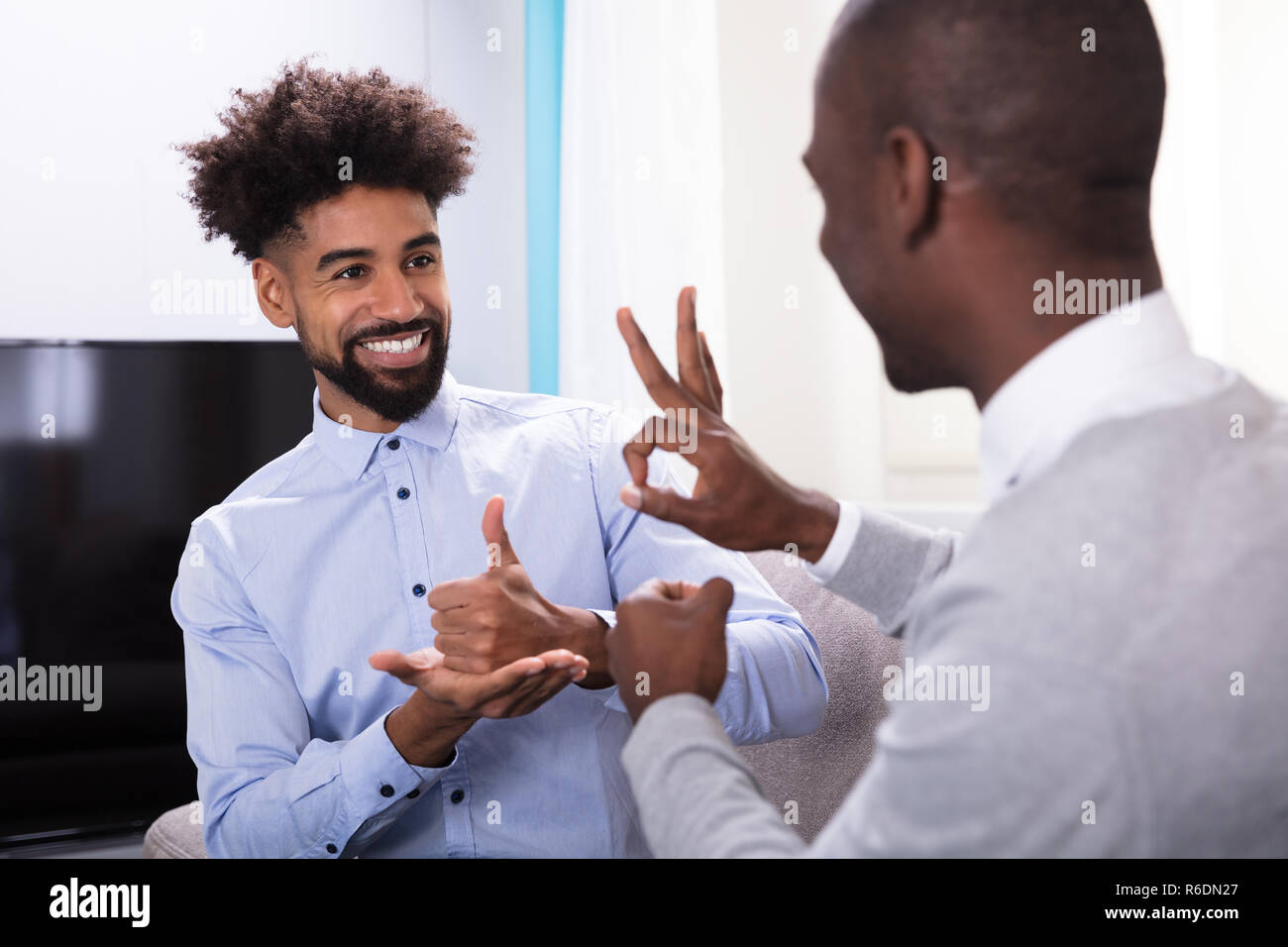 Two Happy Men Making Sign Language Stock Photo - Alamy