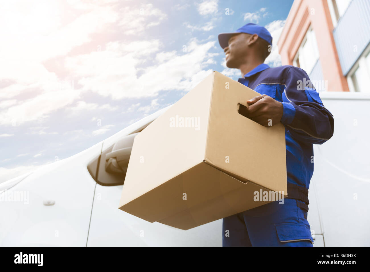 Male loader carrying boxes hi-res stock photography and images - Alamy