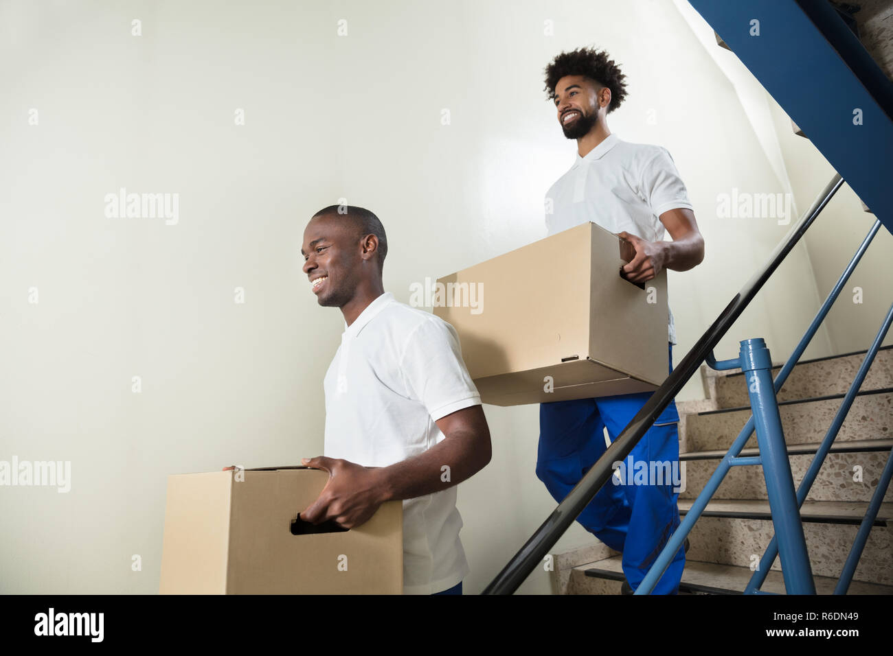 Portrait Of Two Movers Holding Cardboard Boxes Stock Photo - Alamy
