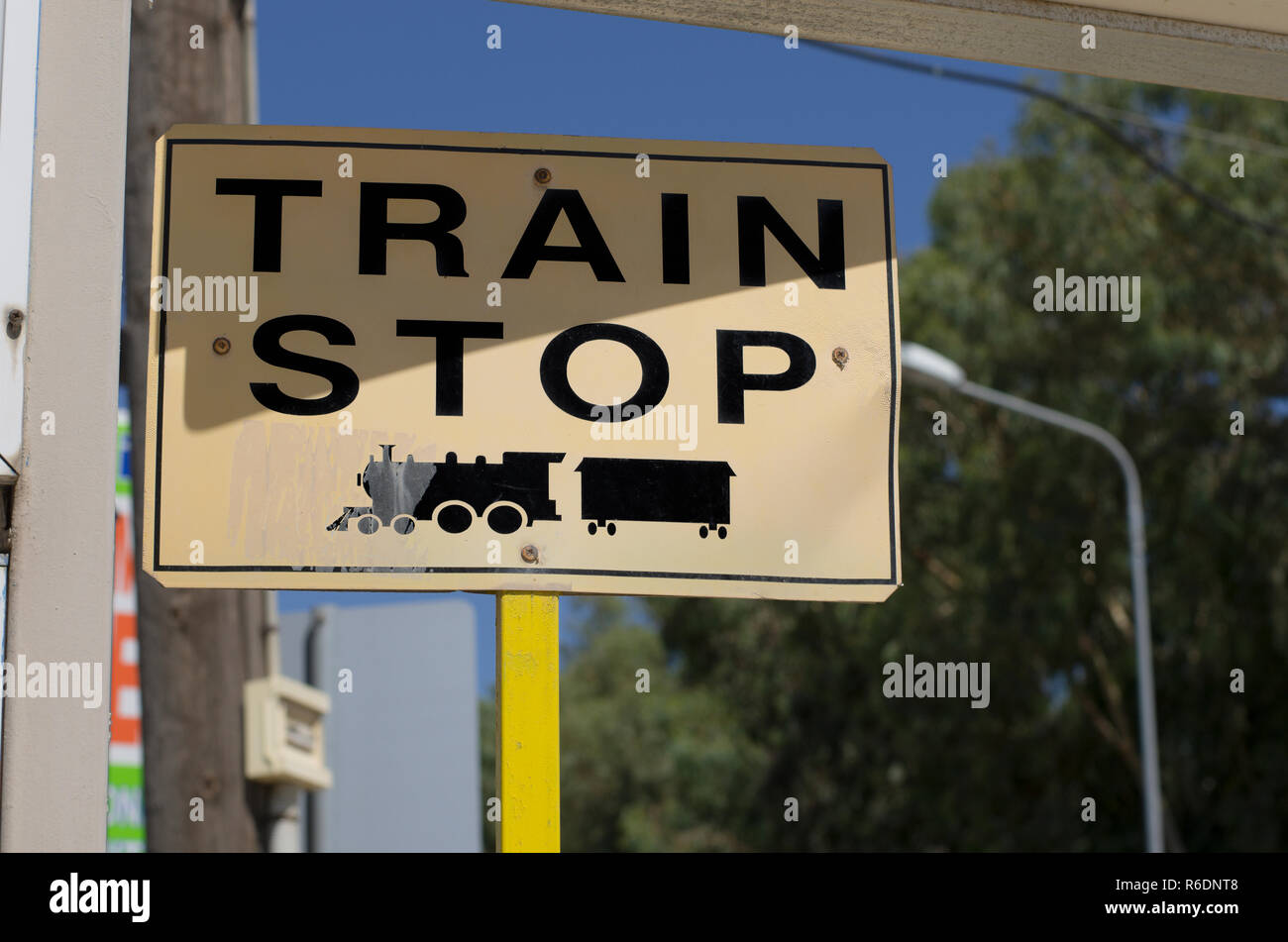 Road sign with the inscription in English "train stop" and the symbol ...