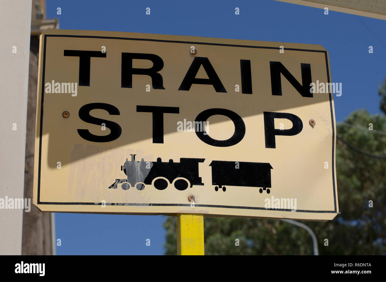 Road sign with the inscription in English "train stop" and the symbol ...