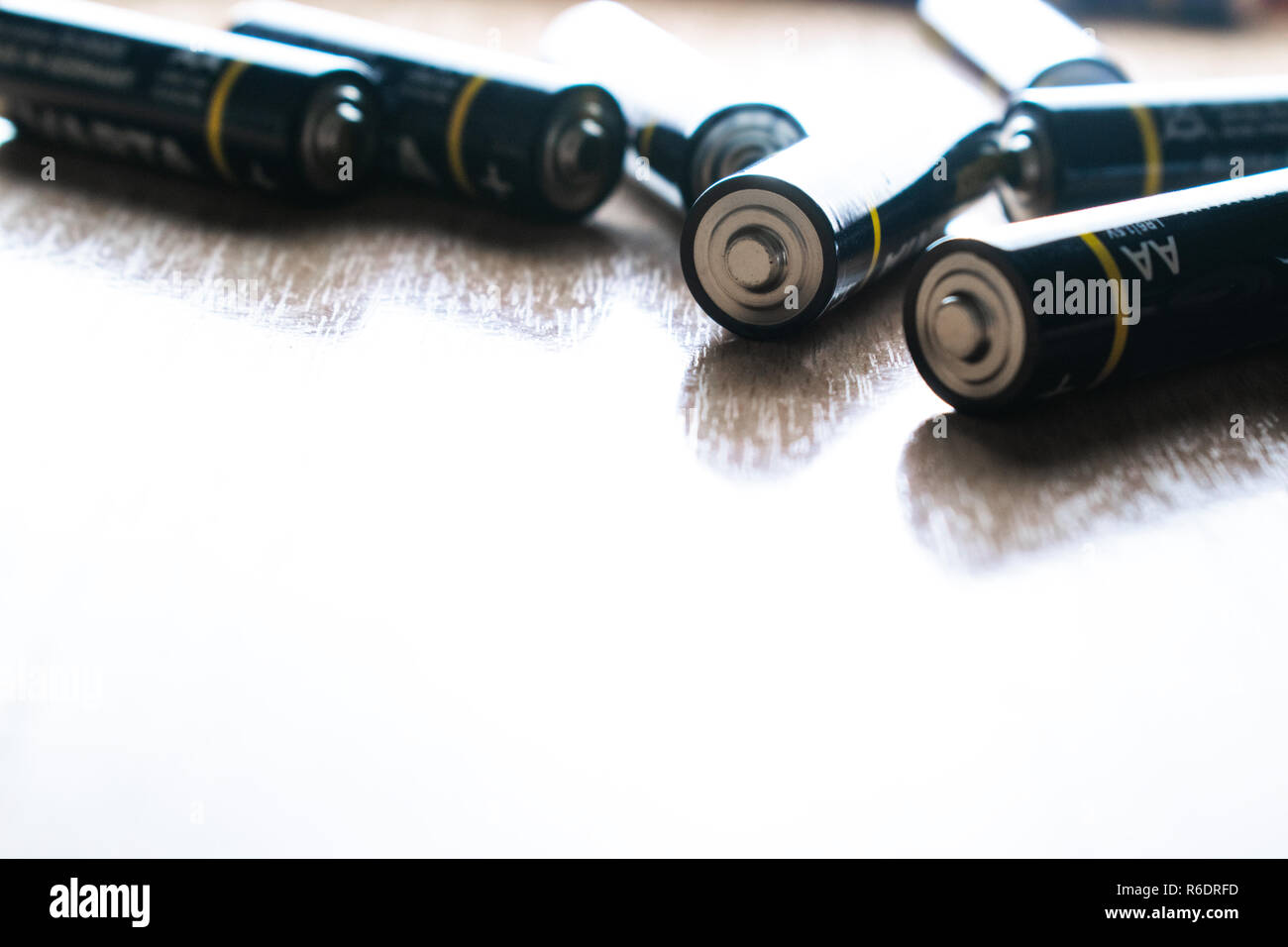 Closeup of pile of used alkaline batteries. Close up colorful rows of ...