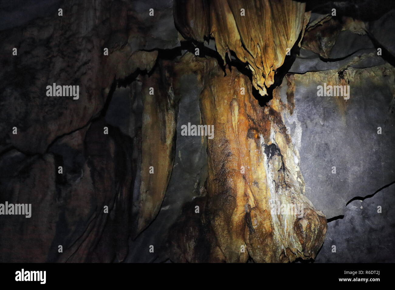 Rock formations of grey limestone with speleogens and reddish ...
