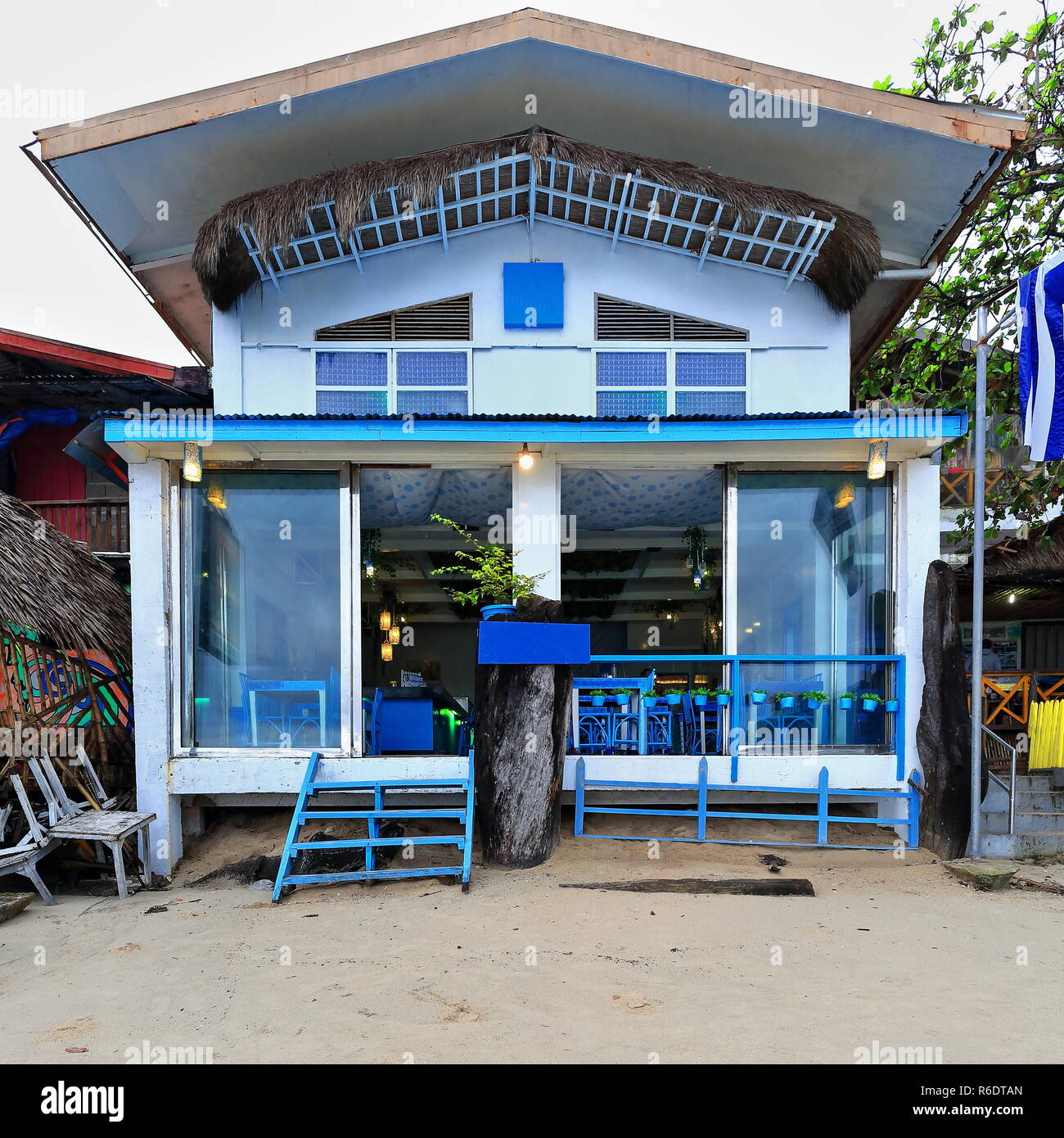 Facade of empty beachfront restaurant open to the sand of the public ...