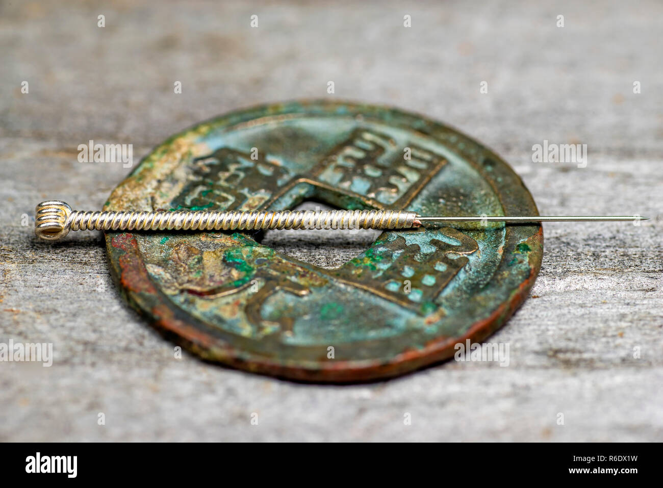 Acupuncture Needle On Antique Chinese Coin Stock Photo - Alamy