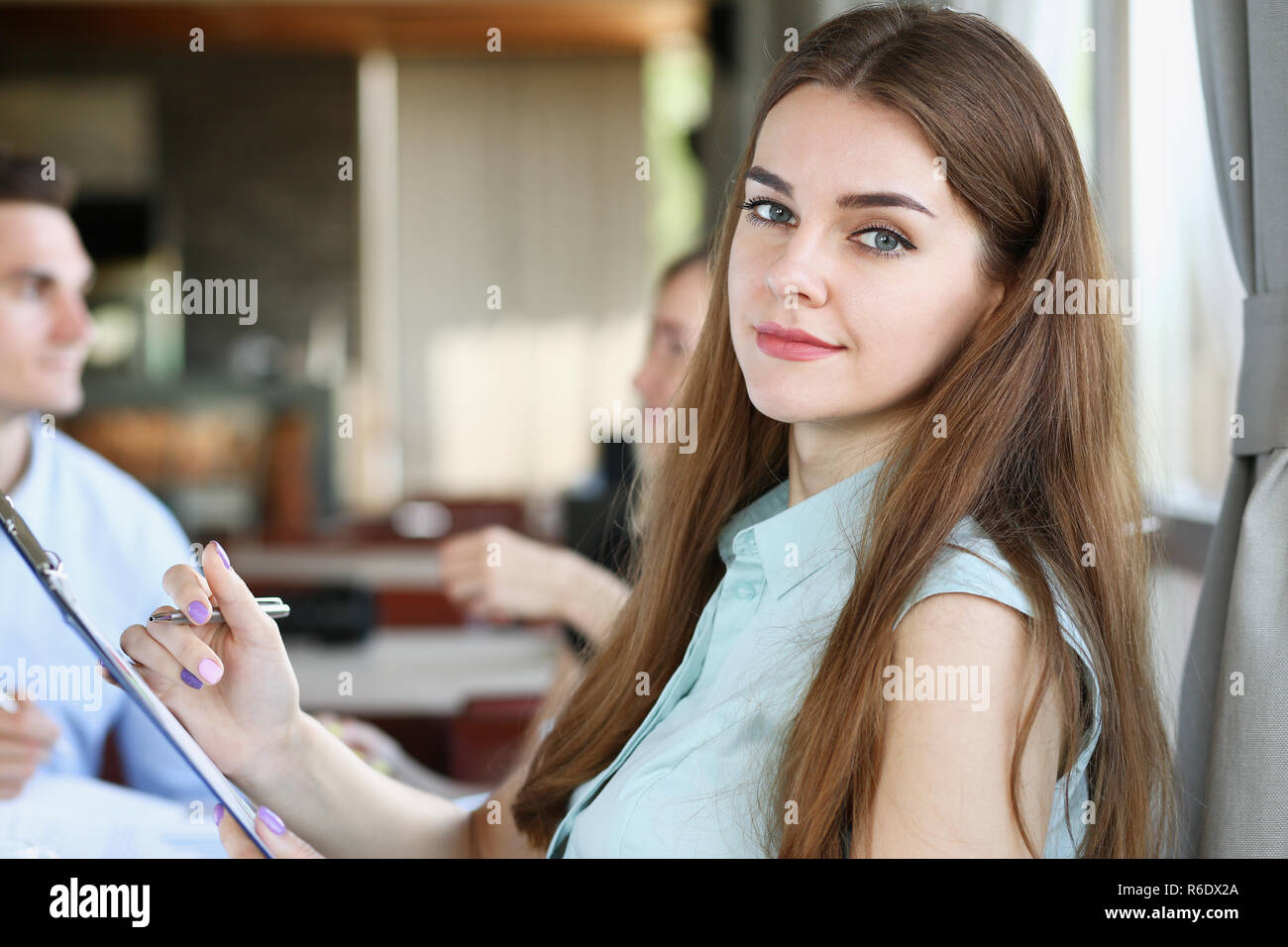Beautiful smiling cheerful girl at workplace Stock Photo - Alamy