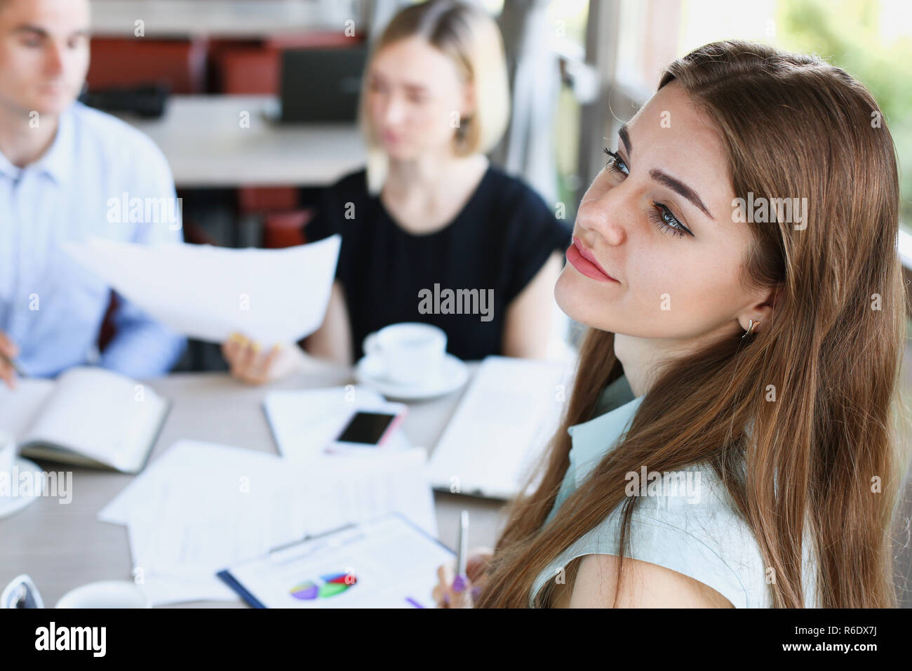 Beautiful smiling cheerful girl at workplace Stock Photo - Alamy