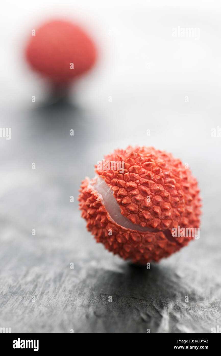 broken lychee on slate Stock Photo - Alamy