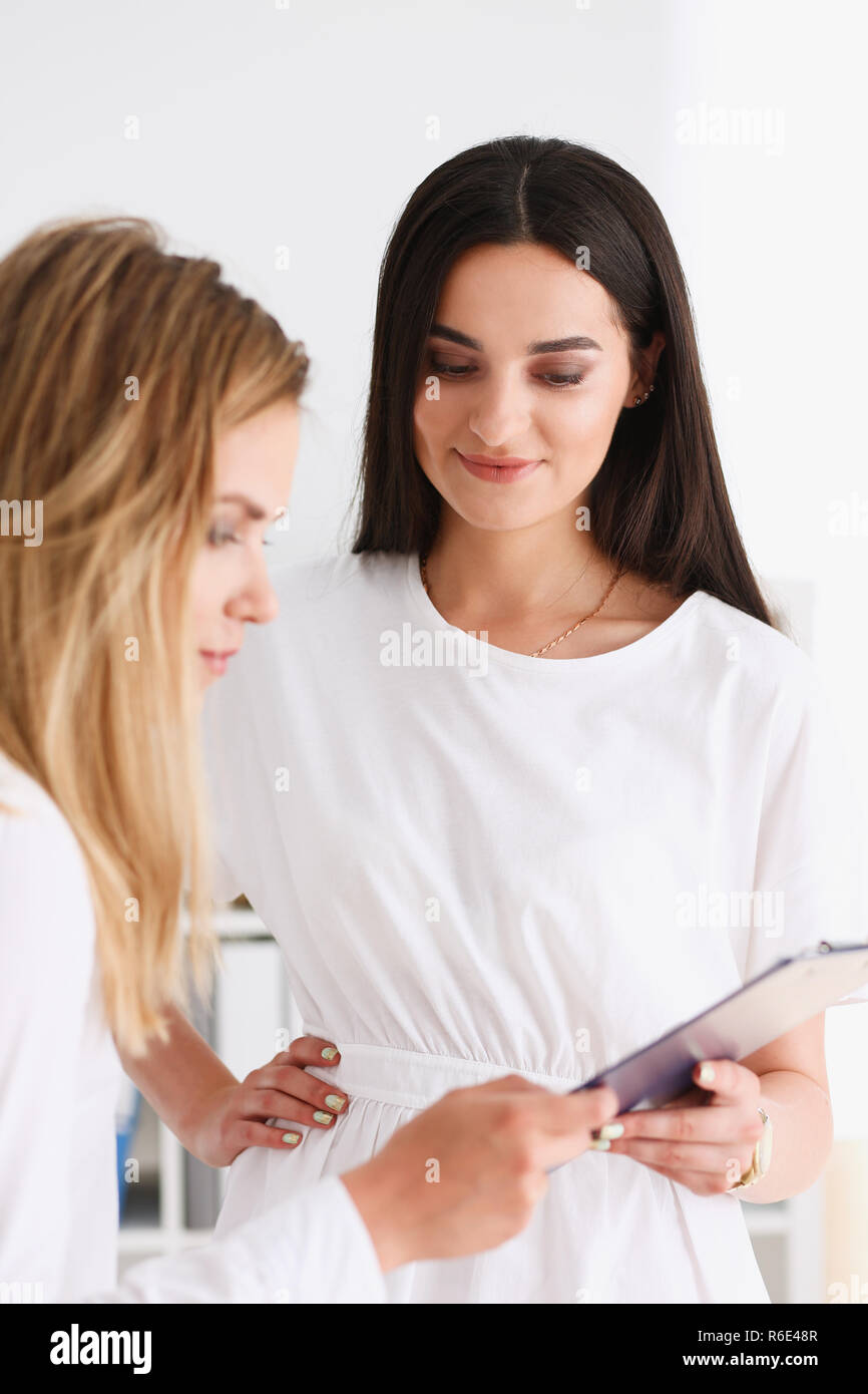 Group of people deliberate on problem clipboard Stock Photo - Alamy