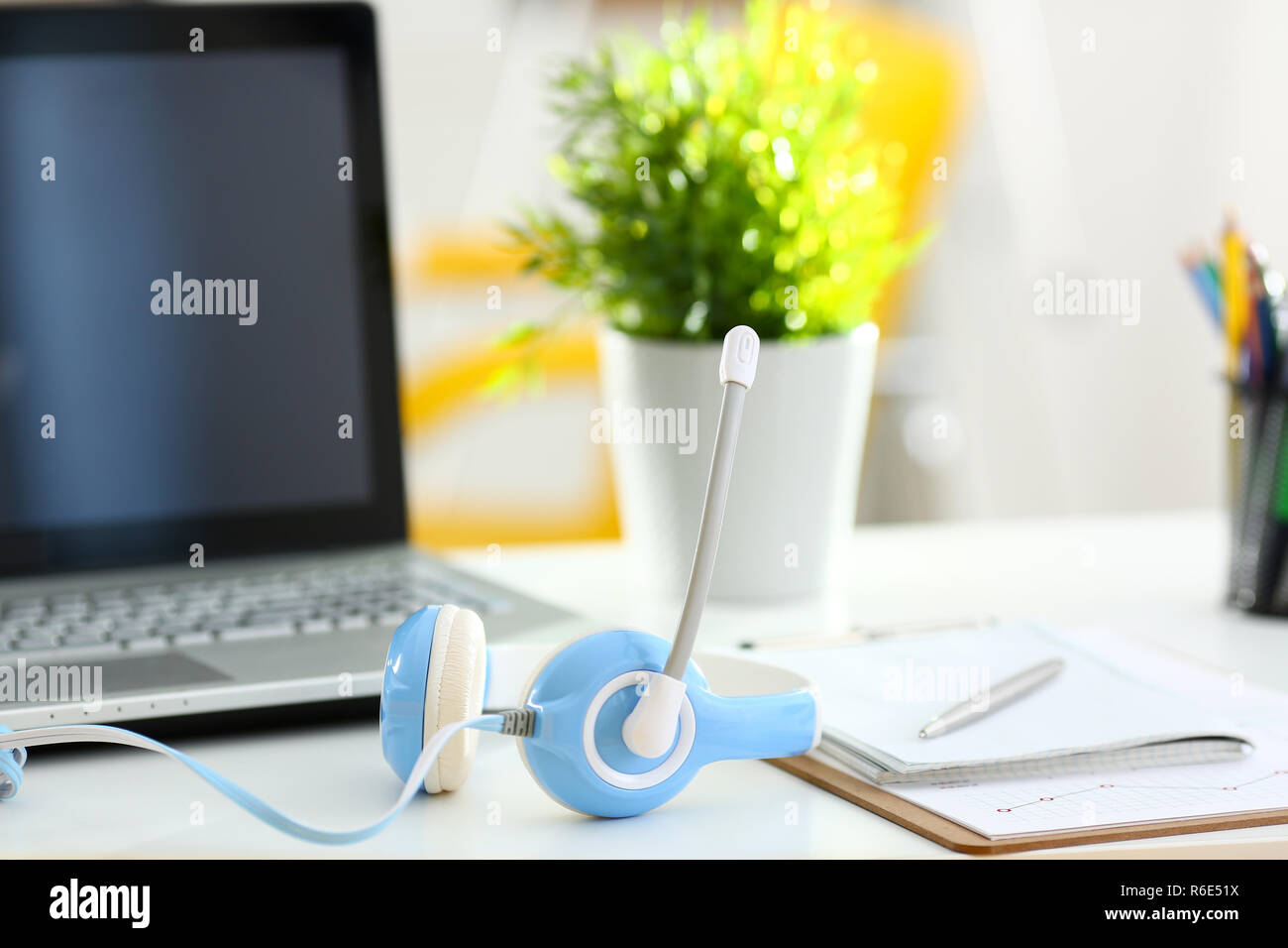 Empty remote office workplace with laptop and headset Stock Photo - Alamy