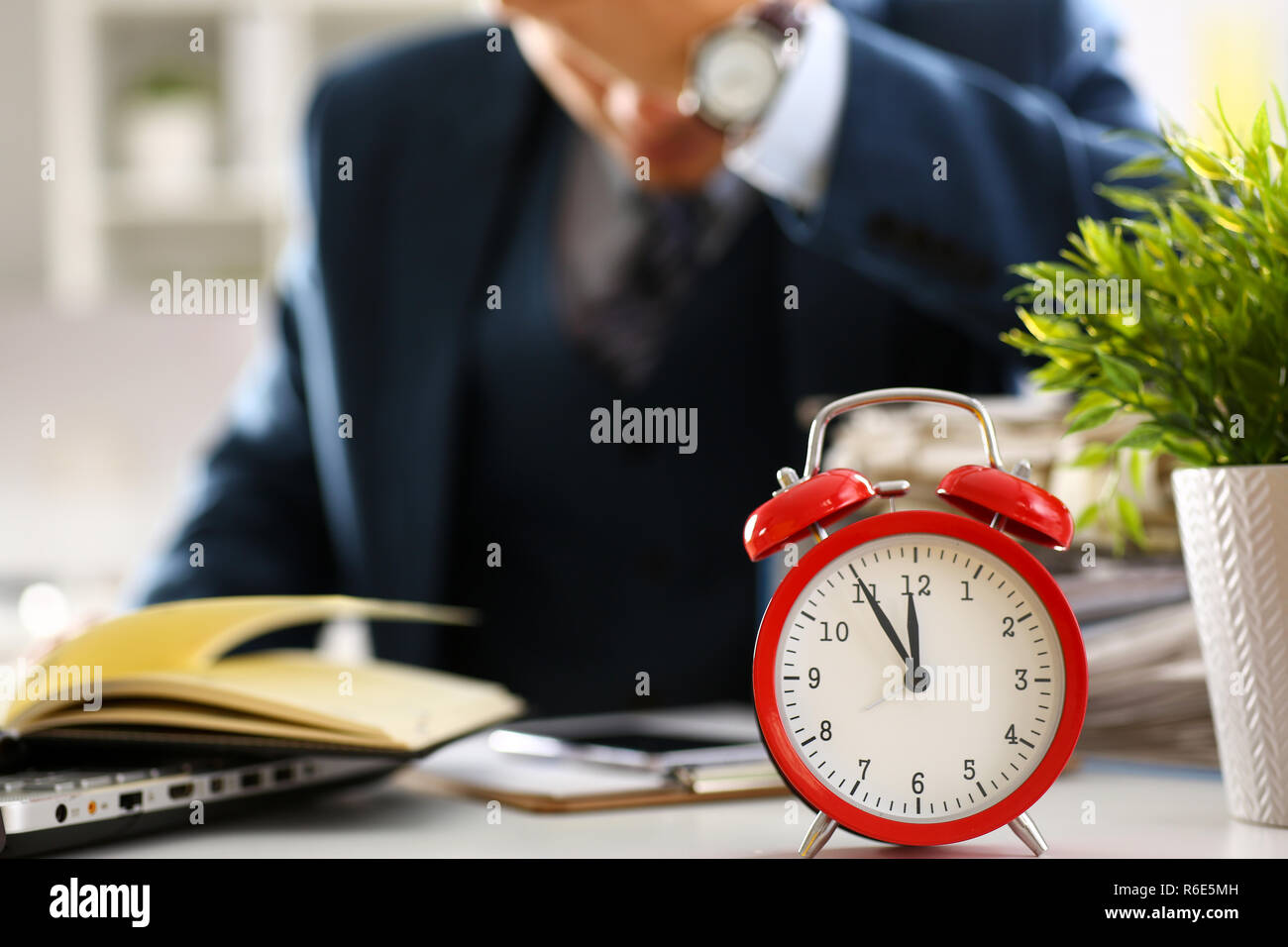 Businessman shows clock hi-res stock photography and images - Alamy