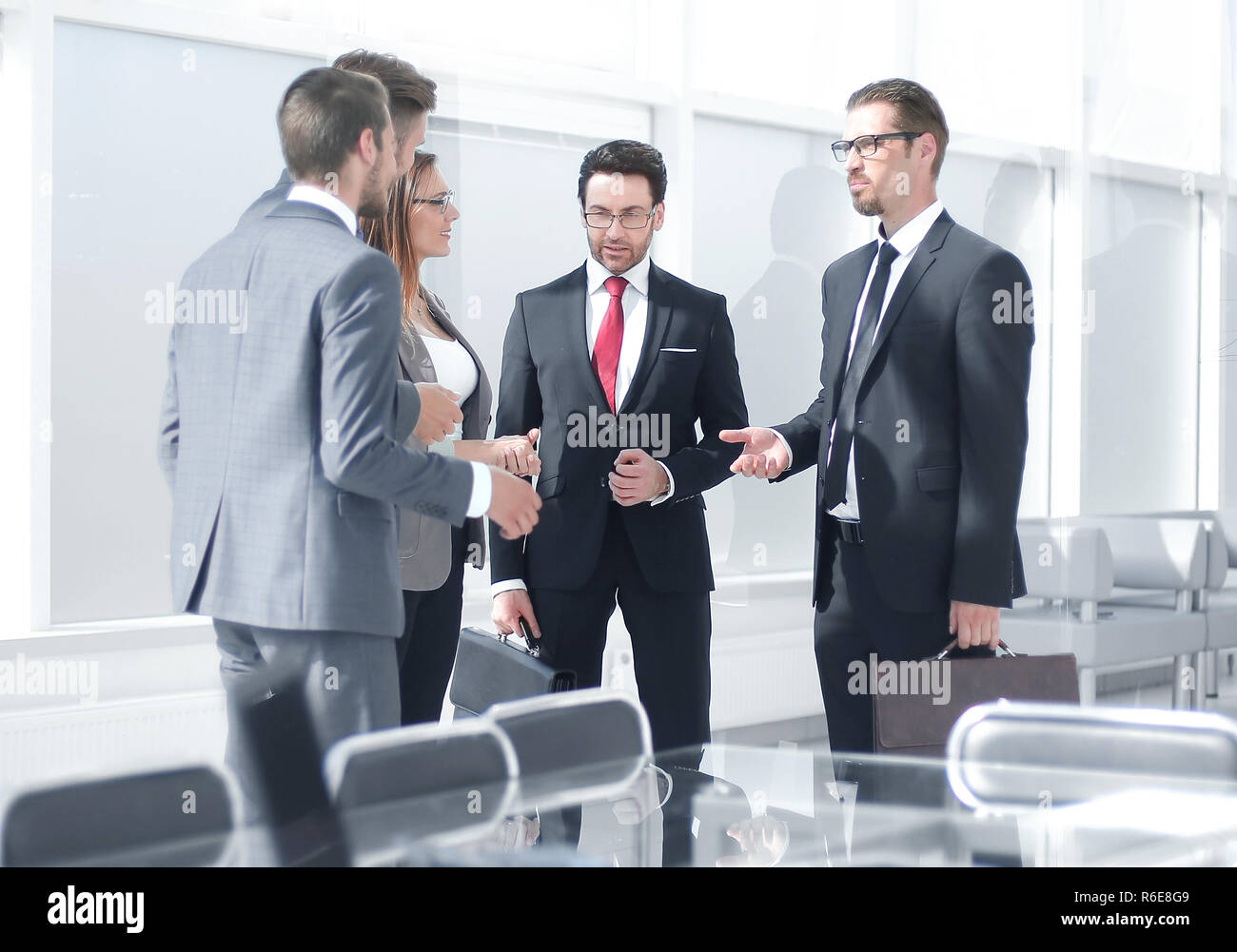employees talking standing in the office Stock Photo - Alamy