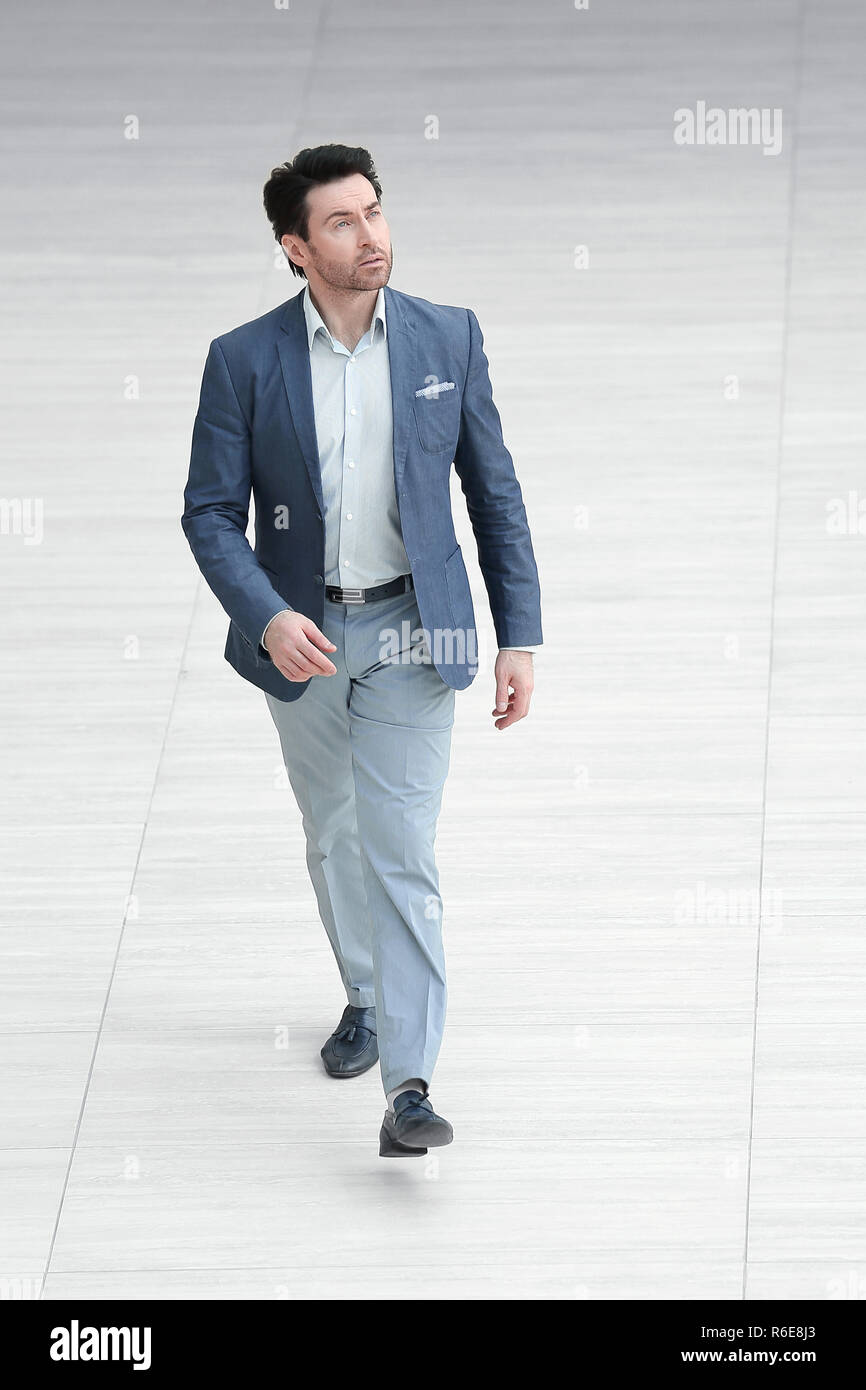 Young white male walking confidently hi-res stock photography and ...