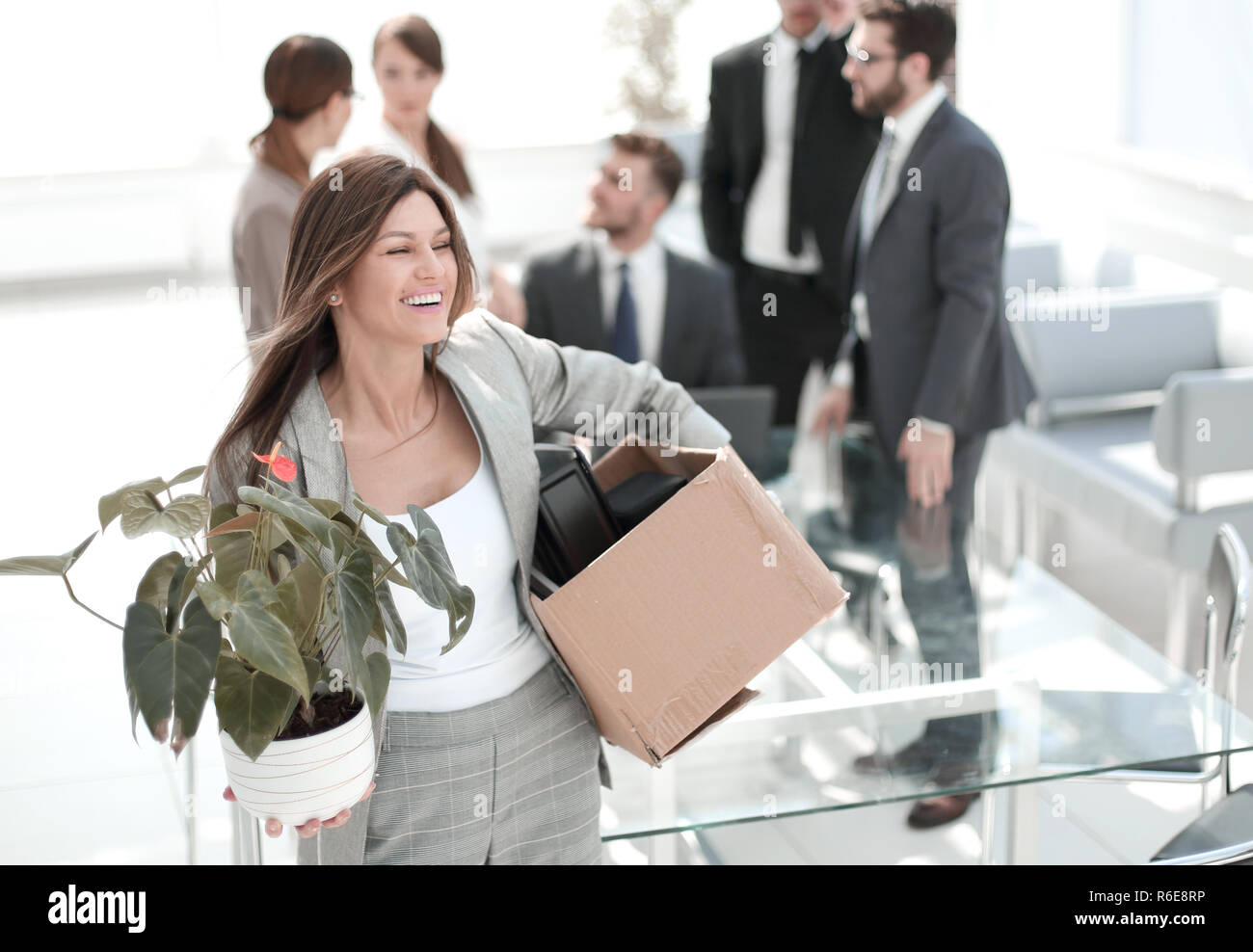 Young happy business woman with boxes for moving into a new office ...
