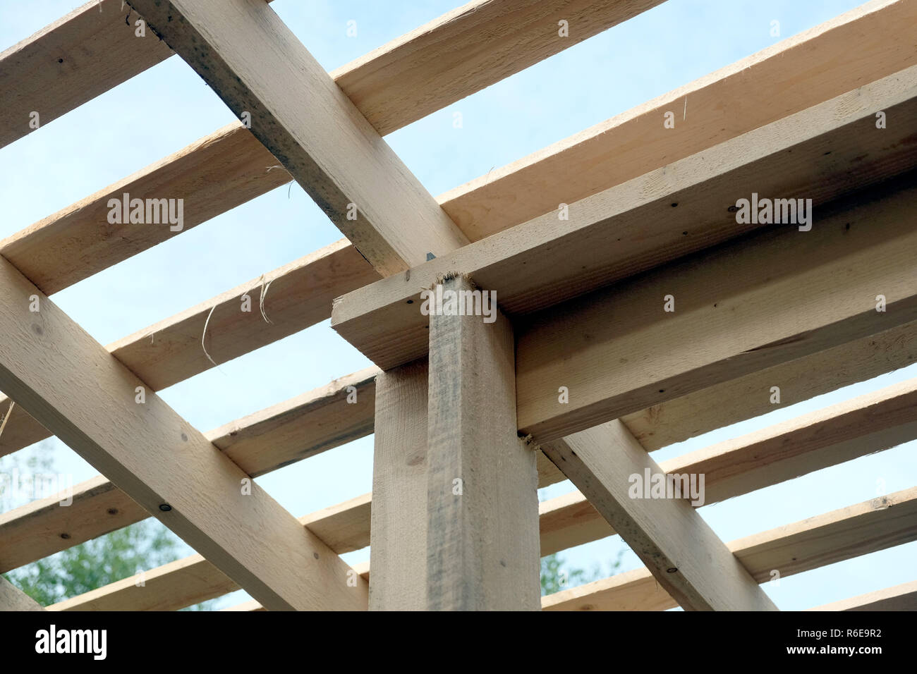 Roof lathing mounting inside house. Wooden country house construction ...