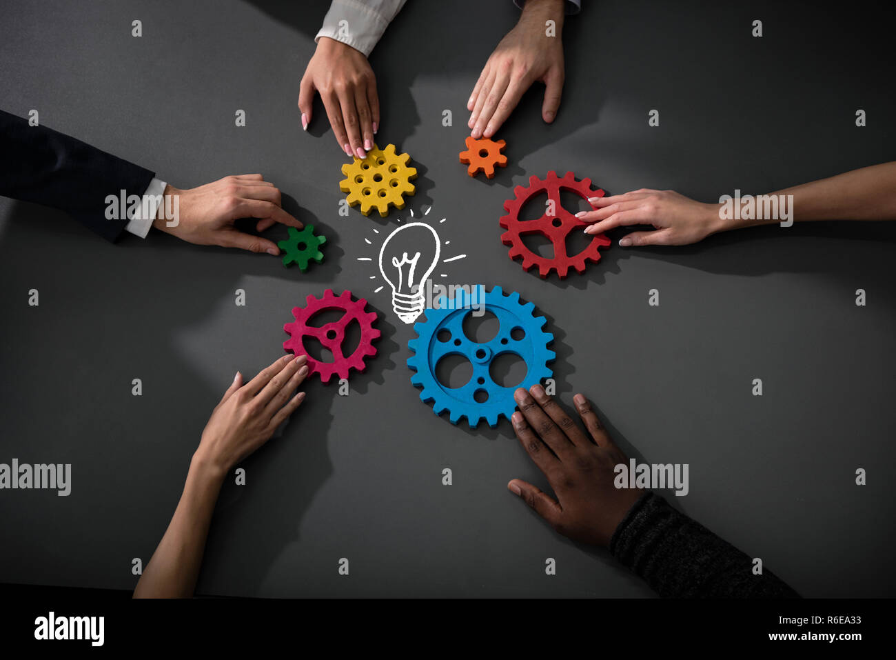 Business team connect pieces of gears to build a new creative idea ...