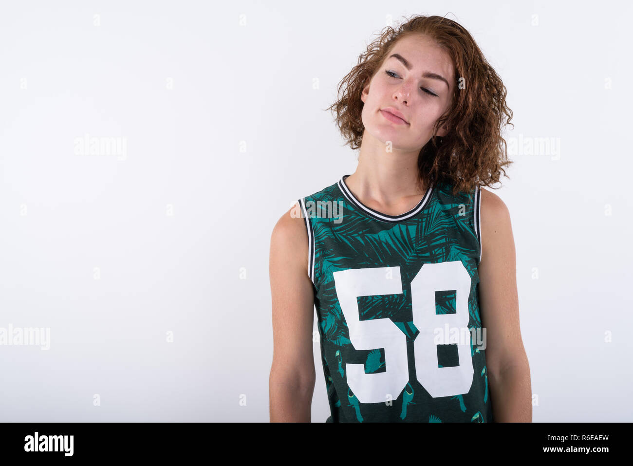 Studio shot of beautiful teenage girl thinking while looking to Stock ...