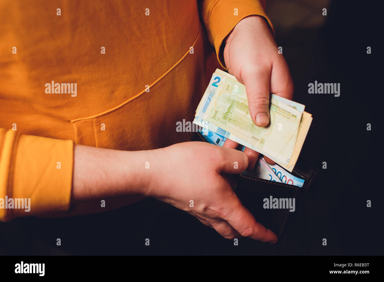 People holding a wallet in hand, Chinese yuan money Stock Photo - Alamy