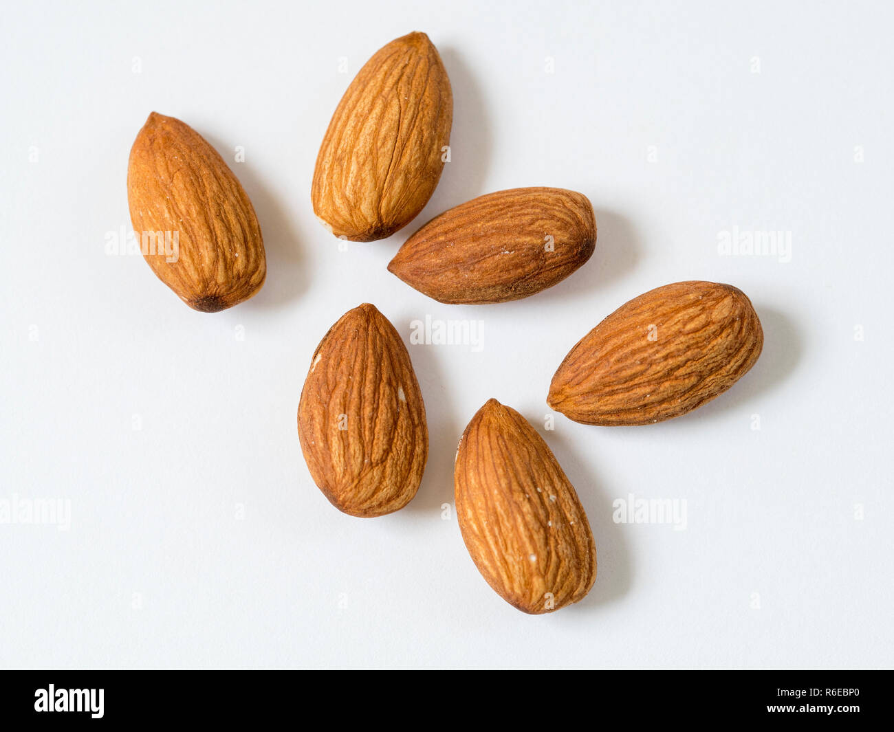 Almonds on plain white background Stock Photo - Alamy