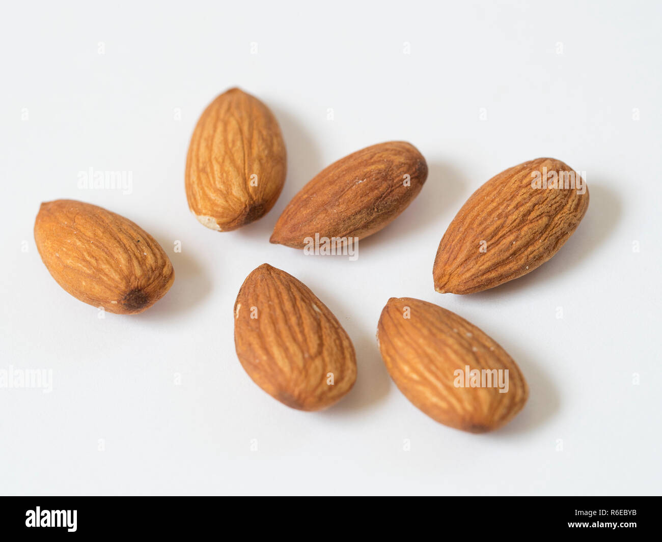 Cluster of almonds on plain white background Stock Photo - Alamy
