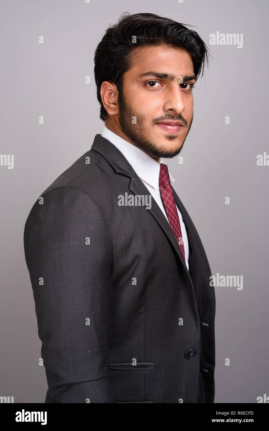Portrait of Indian businessman against gray background Stock Photo - Alamy