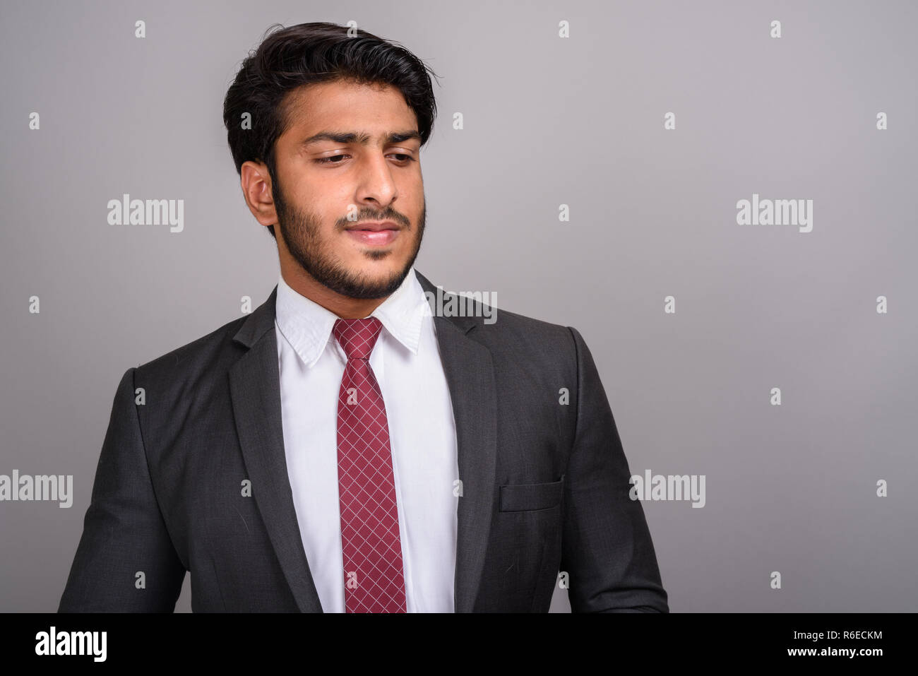 Portrait of Indian businessman against gray background Stock Photo - Alamy