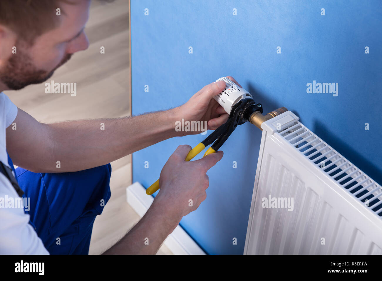 Repairman Fixing Radiator With Wrench Stock Photo - Alamy