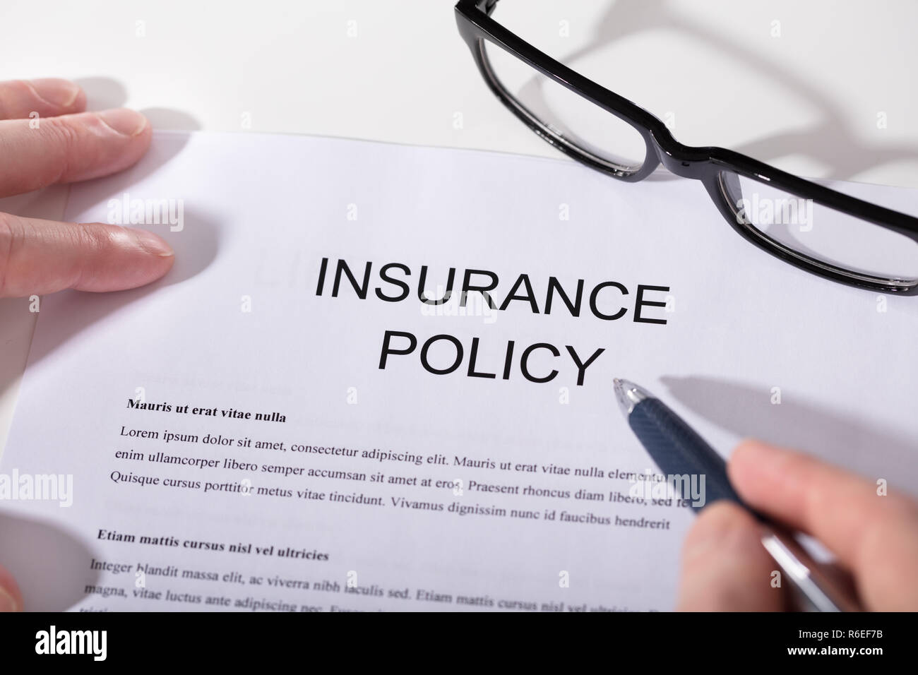 Person's Hand Over Insurance Policy Form Stock Photo - Alamy