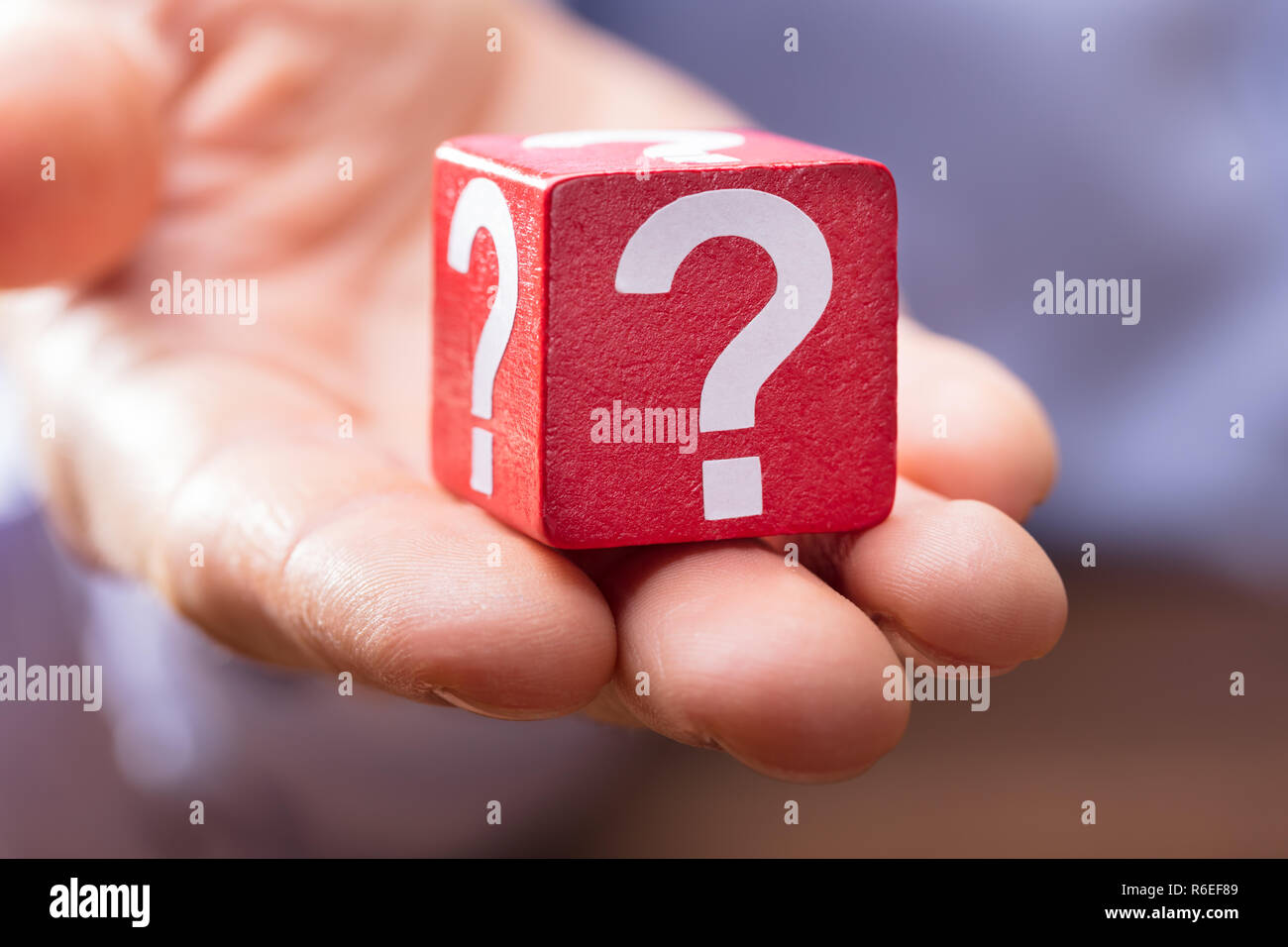 Person Showing Question Mark On The Red Wooden Block Stock Photo - Alamy