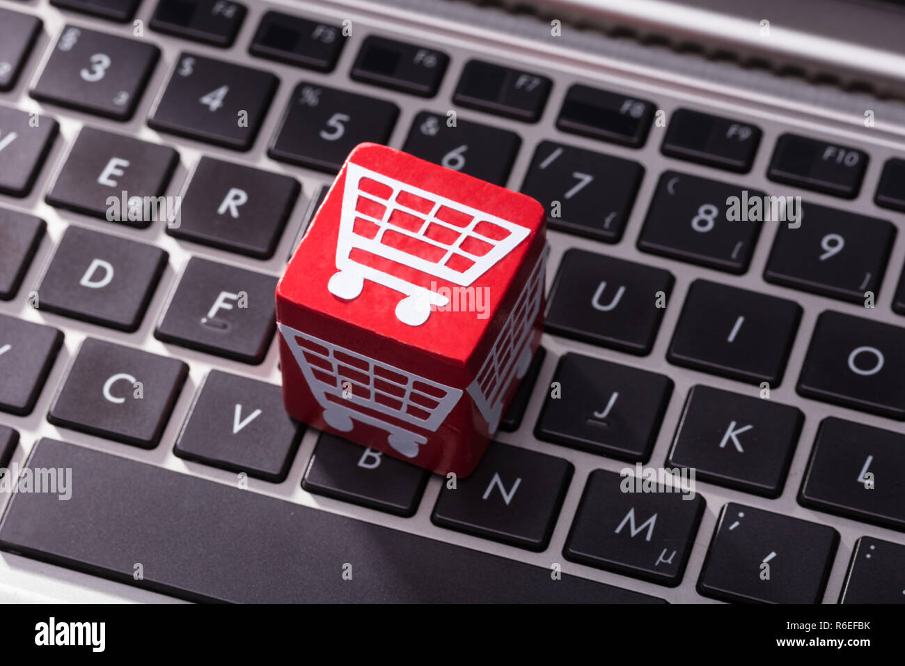 Shopping Cart Symbol Block Over The Laptop Keypad Stock Photo - Alamy