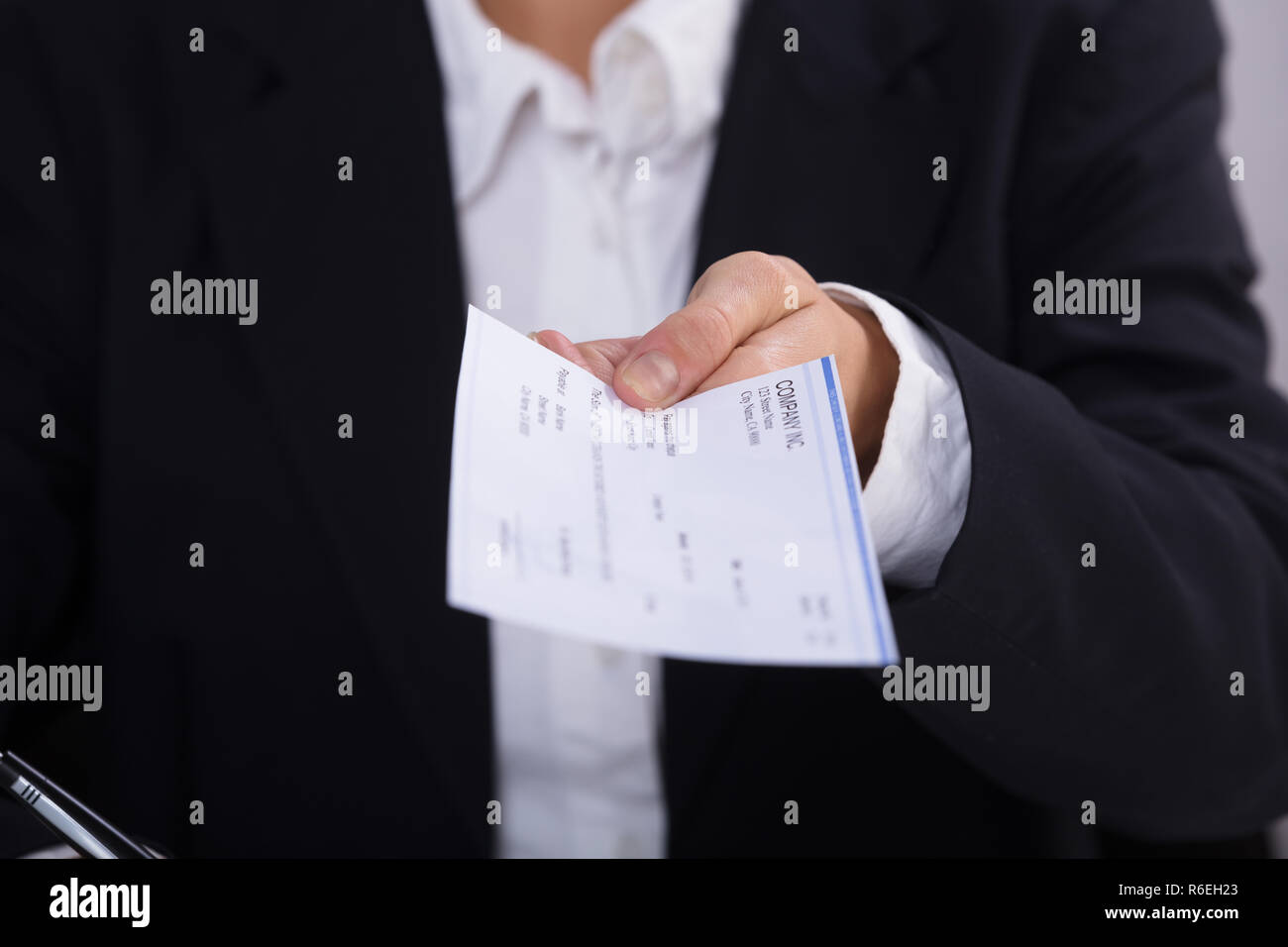 Businessperson's Hand Holding Cheque Stock Photo - Alamy