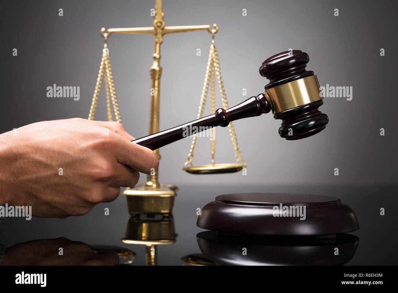 Judge Striking Gavel On Sounding Block Stock Photo - Alamy