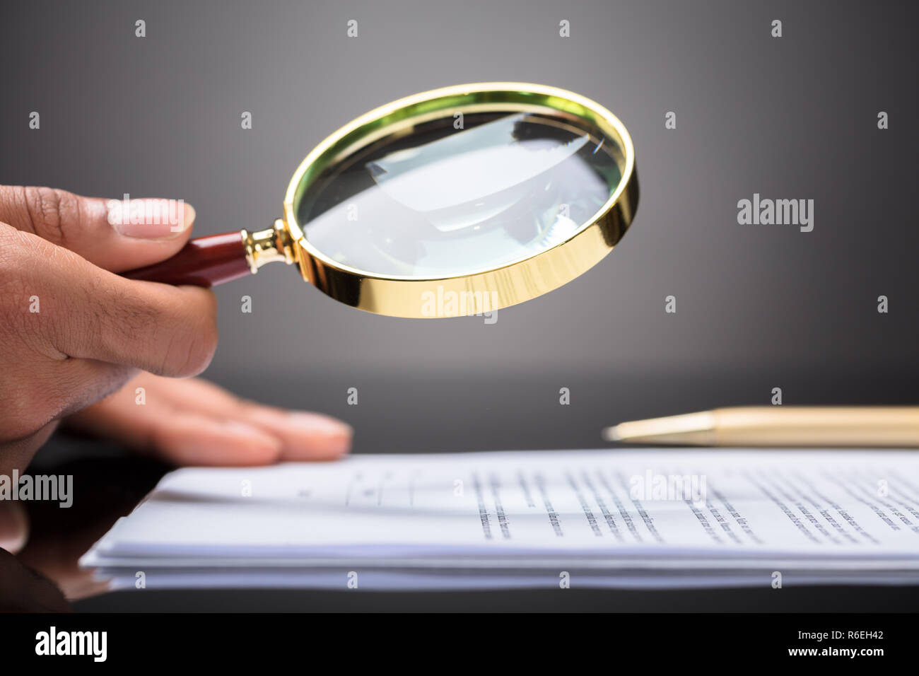 Examining documents magnifying glass hi-res stock photography and ...