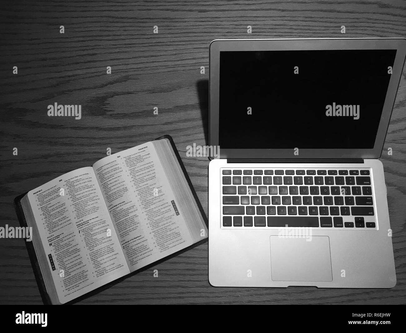 Doing devotions at the table with a laptop and the Bible Stock Photo ...